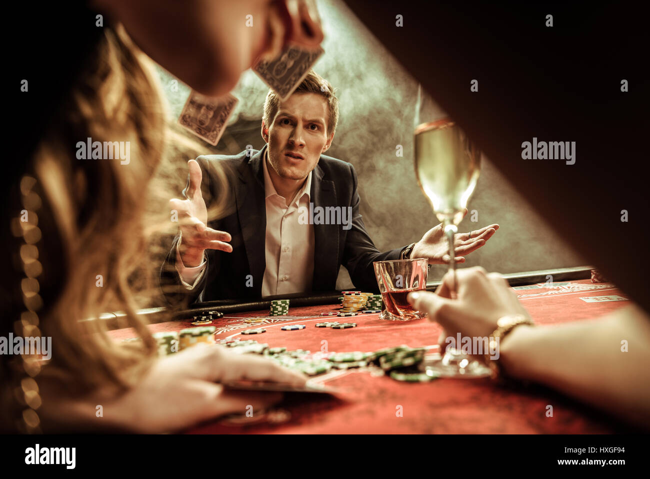 angry man throwing cards while playing poker Stock Photo - Alamy