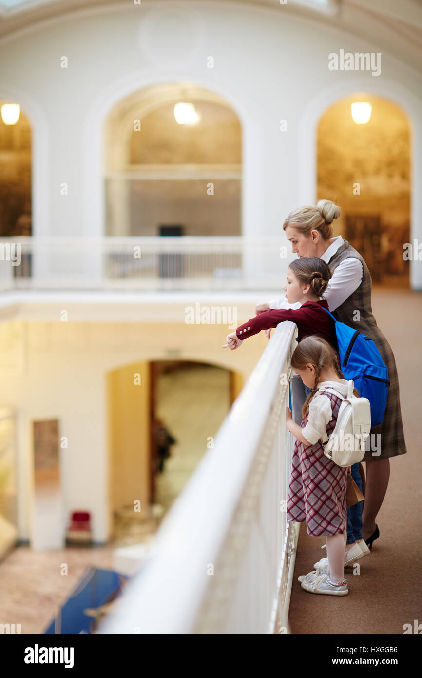Schoolgirls and their teacher spending leisure in museum Stock Photo ...