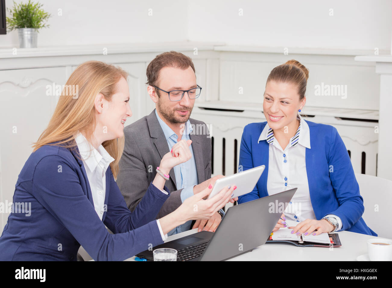Group of business people meeting around conference table Stock Photo ...