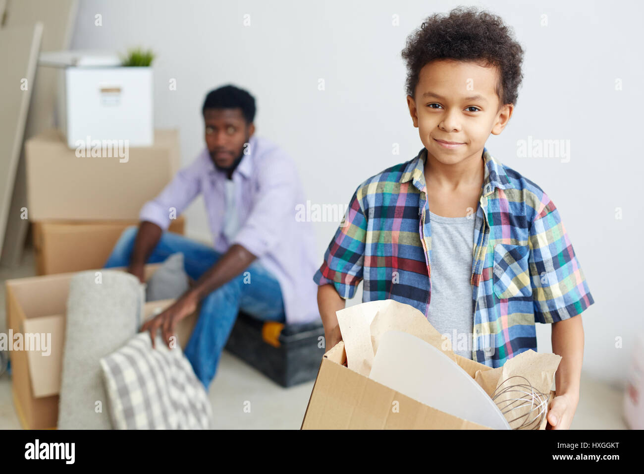 Son with carton-box and his father on background Stock Photo - Alamy