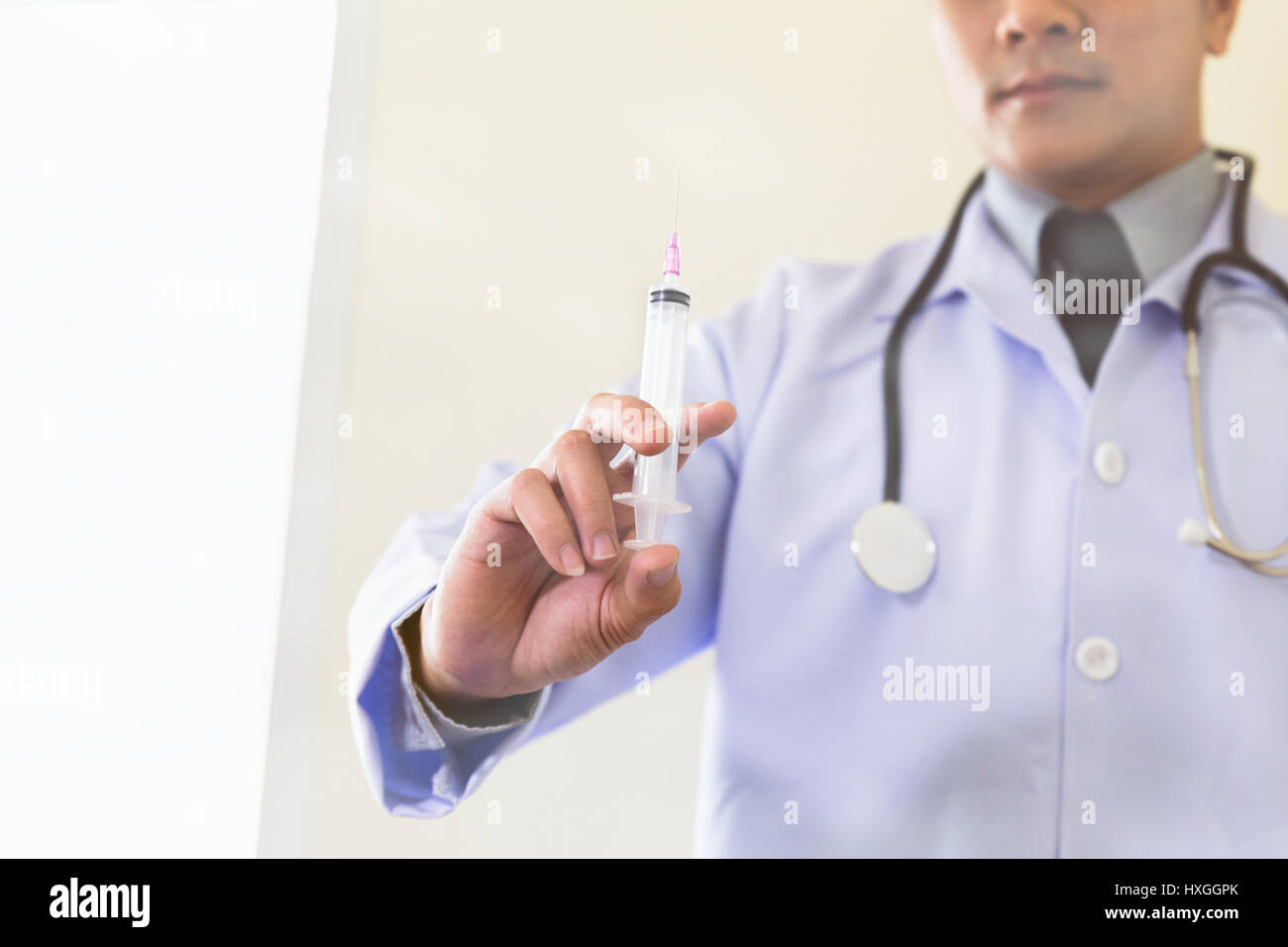 Doctor in white coat ready to make injection. Syringe, medical ...