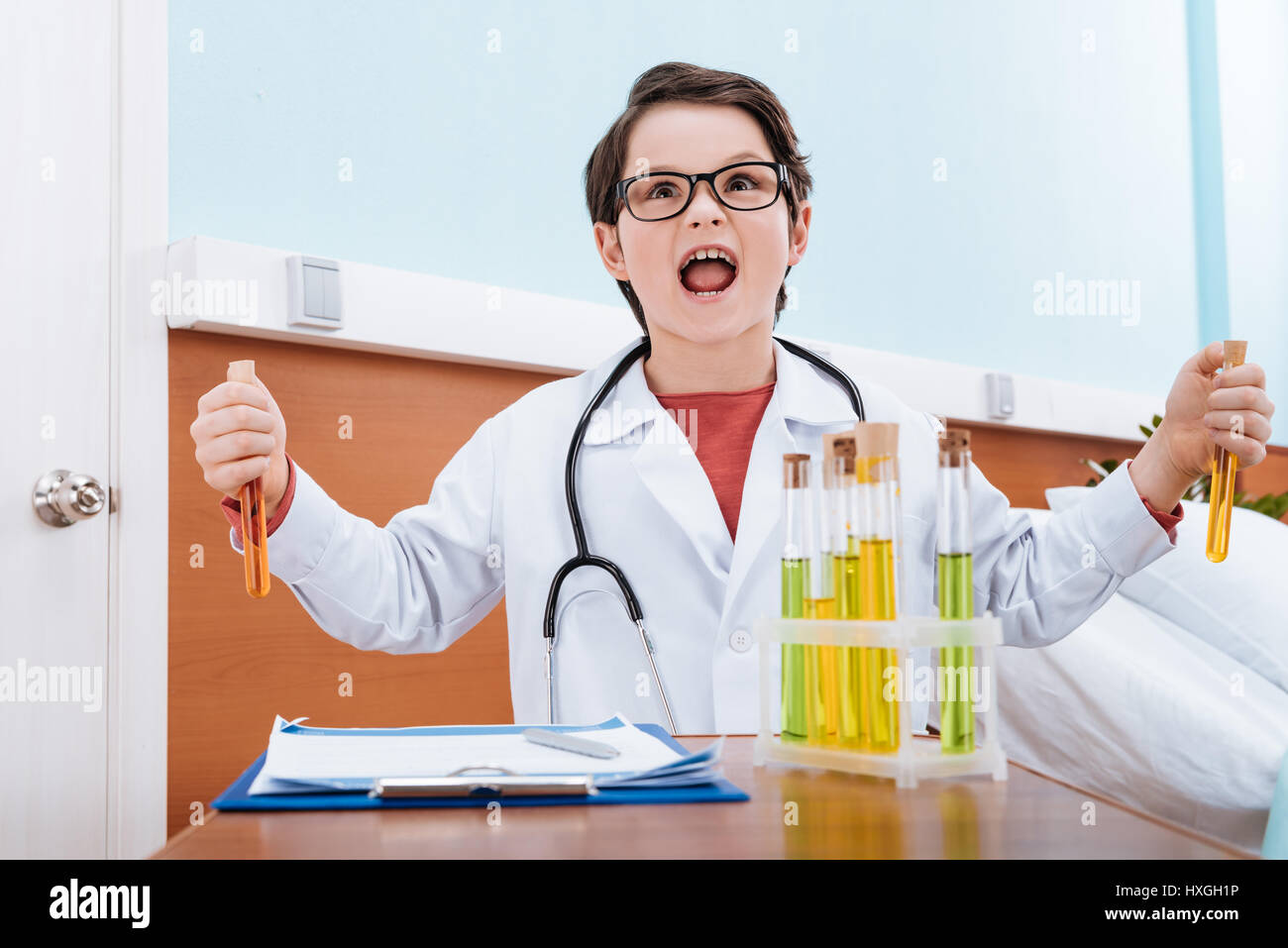 portrait of screaming boy doctor holding test tubes in hospital Stock ...