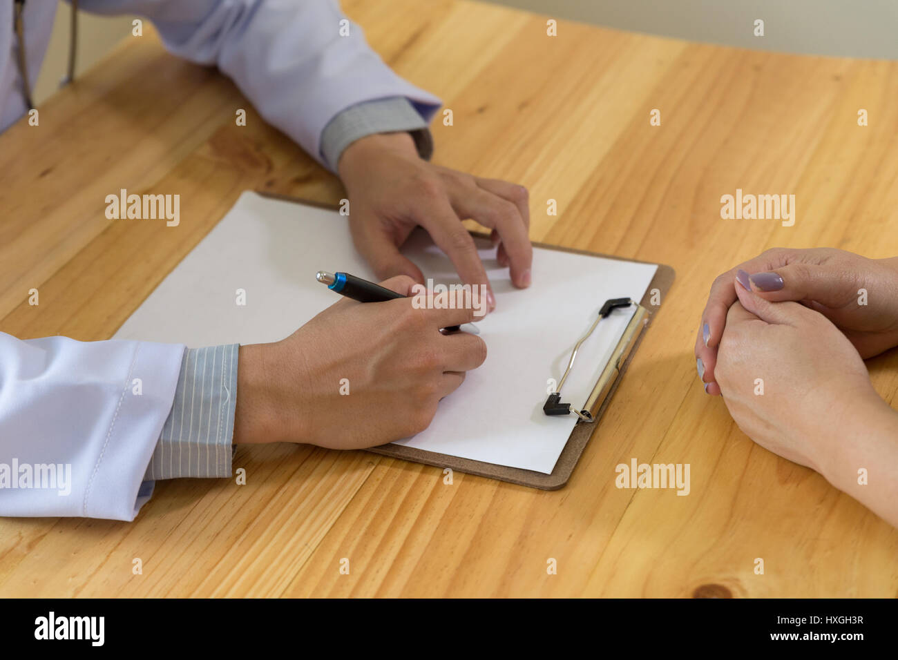 male medicine doctor hand holding pen writing something on clipboard ...