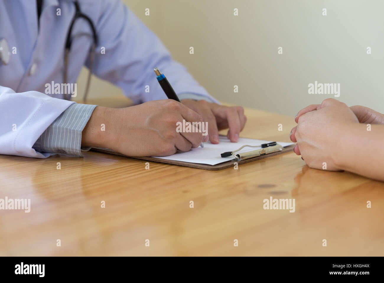 male medicine doctor hand holding pen writing something on clipboard ...