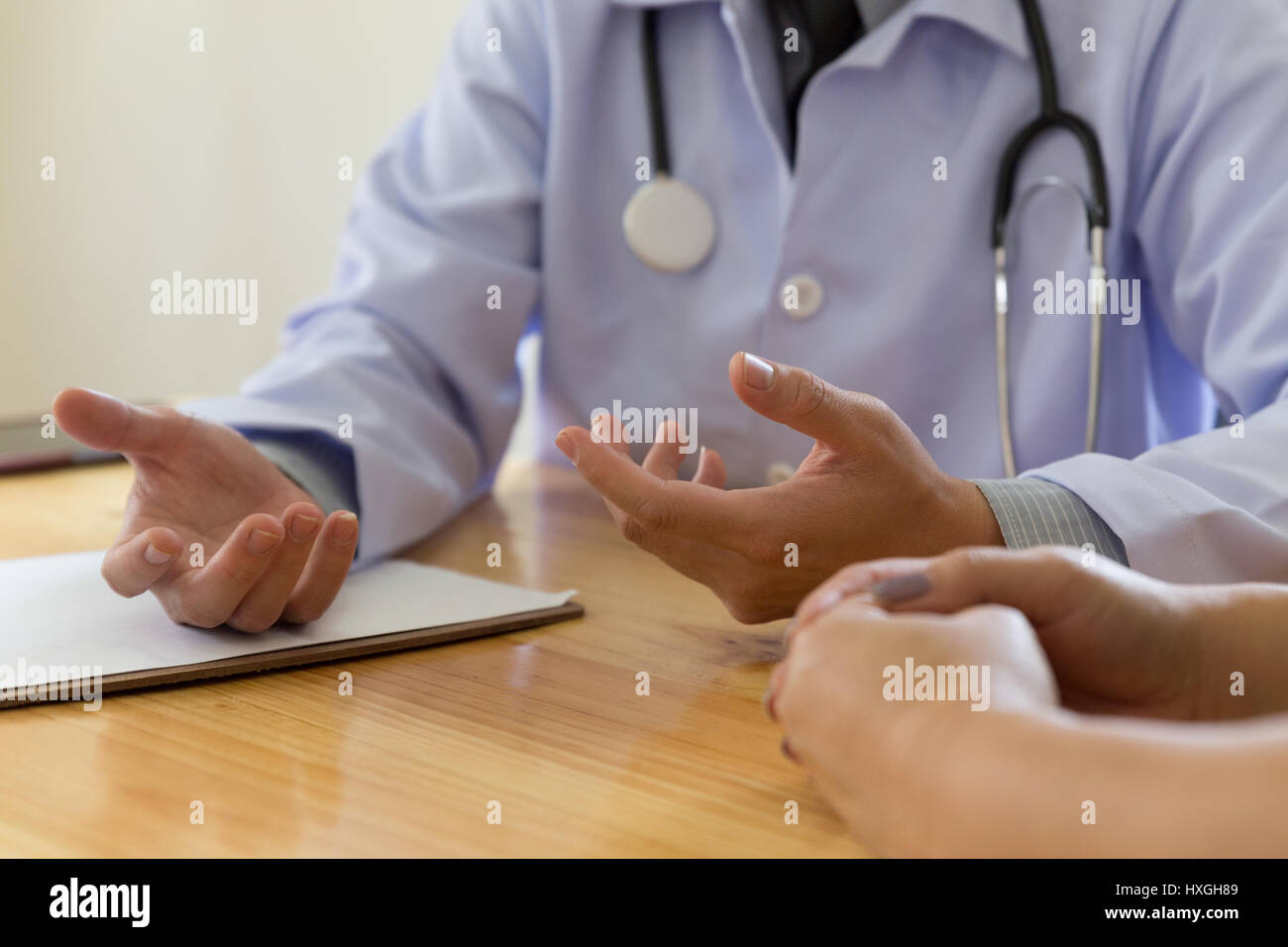 Professional medical doctor in white uniform gown coat consulting ...