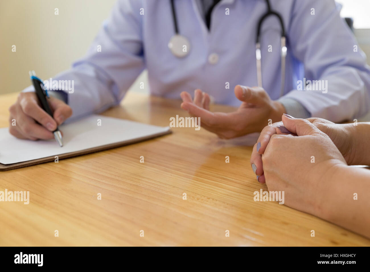 Professional medical doctor in white uniform gown coat consulting ...