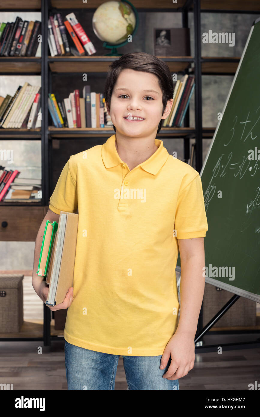 Schoolboy holding books hi-res stock photography and images - Alamy