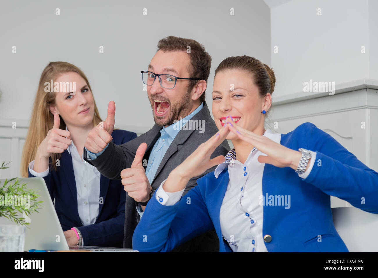 Satisfied team expressing business success Stock Photo - Alamy
