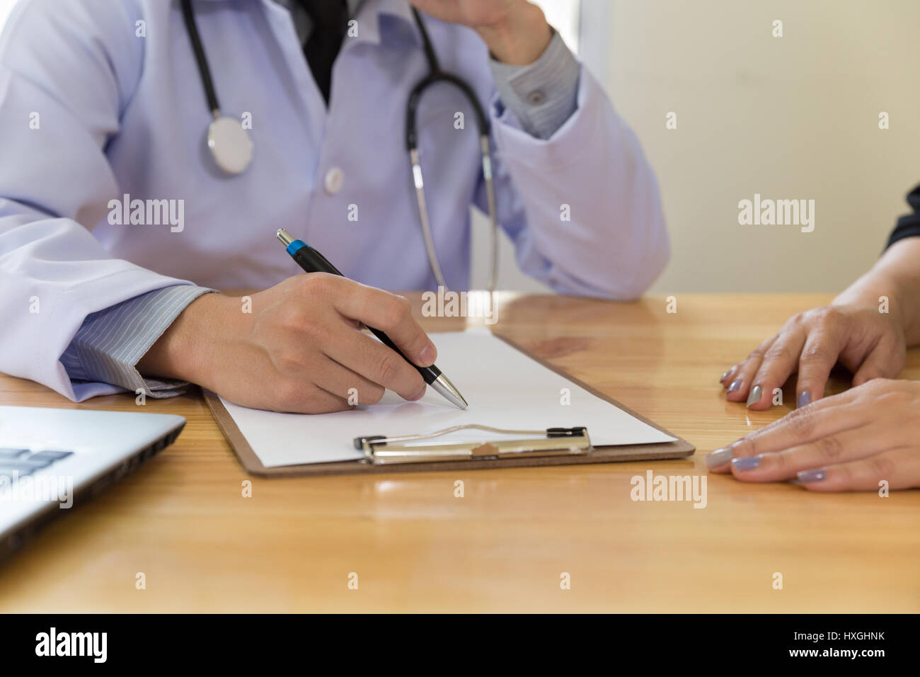 Professional medical doctor in white uniform gown coat consulting ...