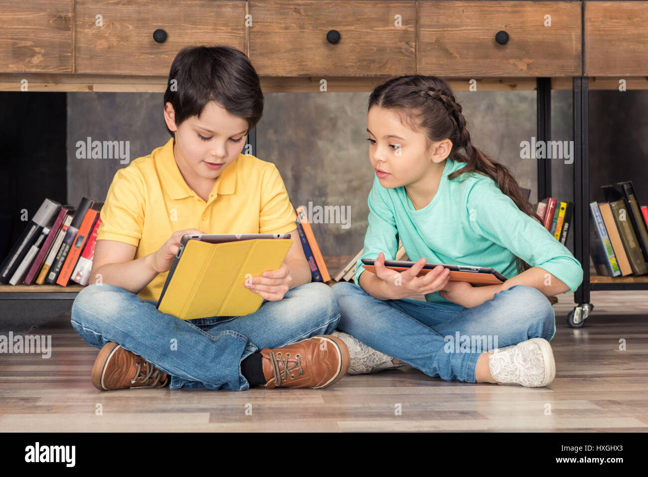 children using digital tablets in library Stock Photo - Alamy