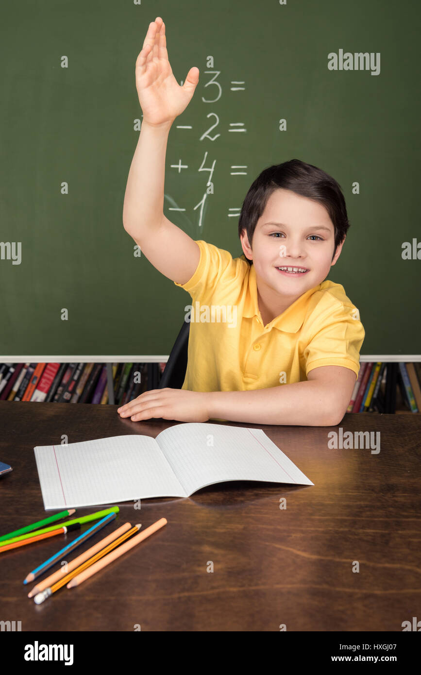 Classroom kid hand up hi-res stock photography and images - Alamy
