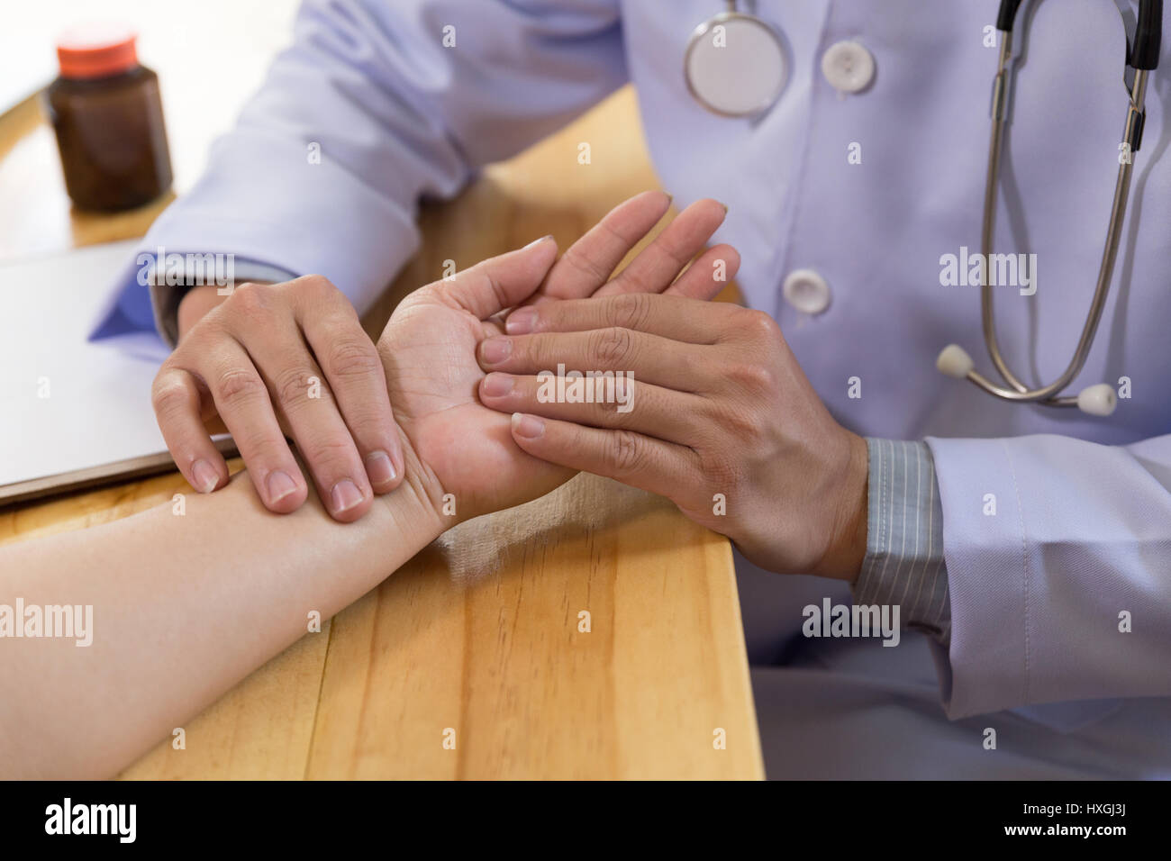 doctor measuring pulse of his senior patient. healthcare and medical ...