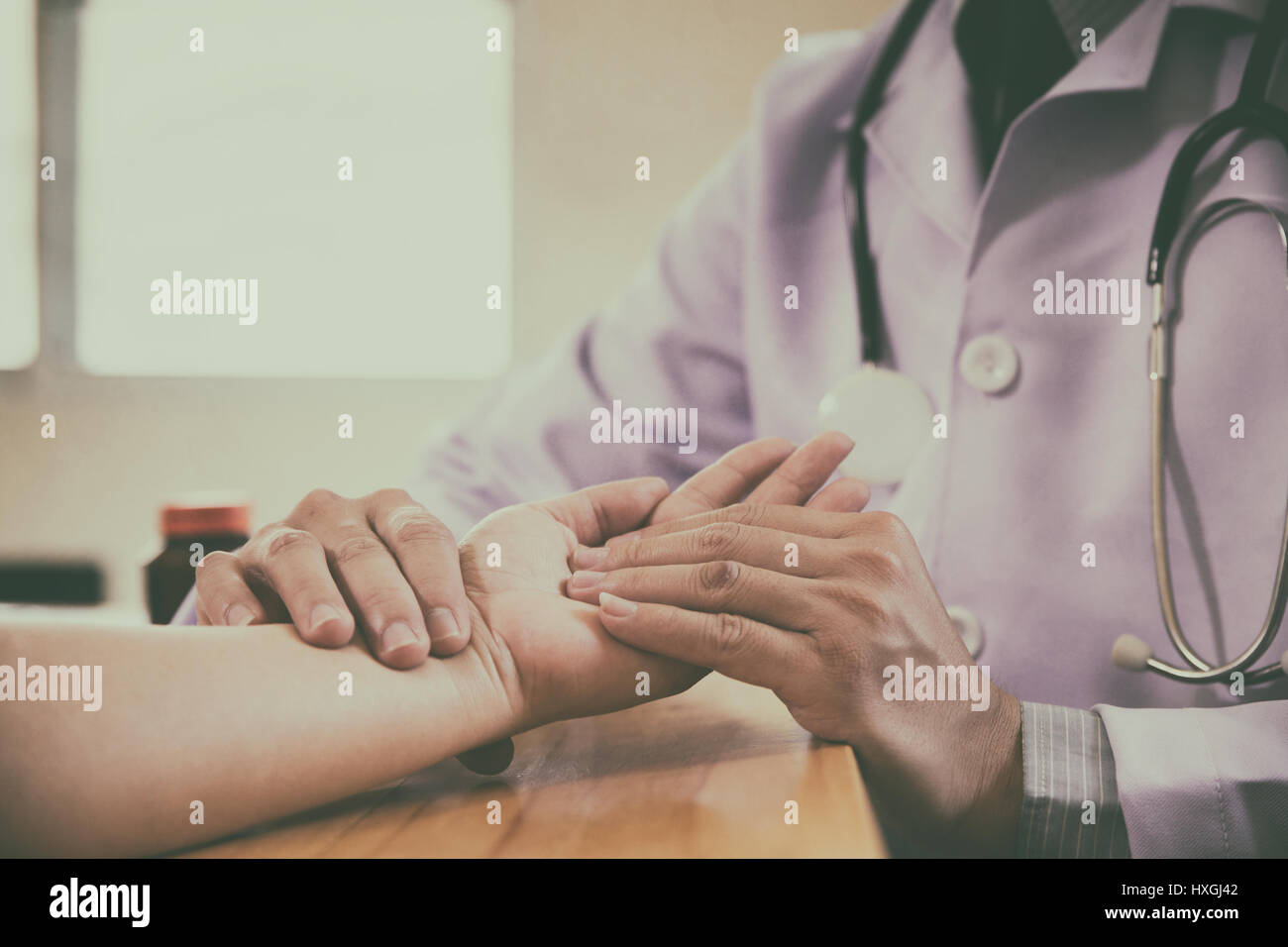 doctor measuring pulse of his senior patient. healthcare and medical ...