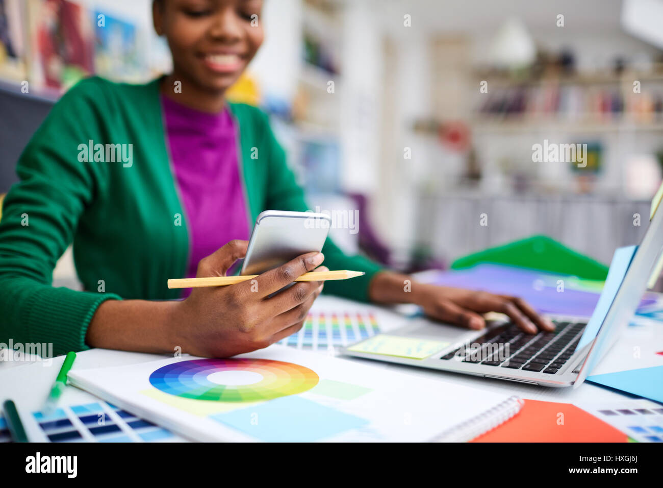 Fashion designer using laptop and smartphone at work Stock Photo - Alamy