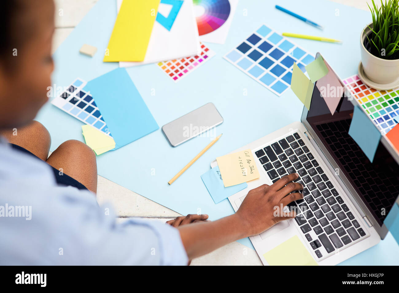 Young woman entering data into laptop or planning work Stock Photo - Alamy