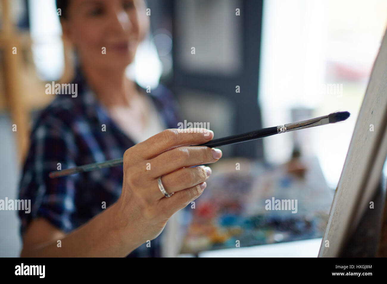 Human hand with paintbrush during course of art studies Stock Photo - Alamy