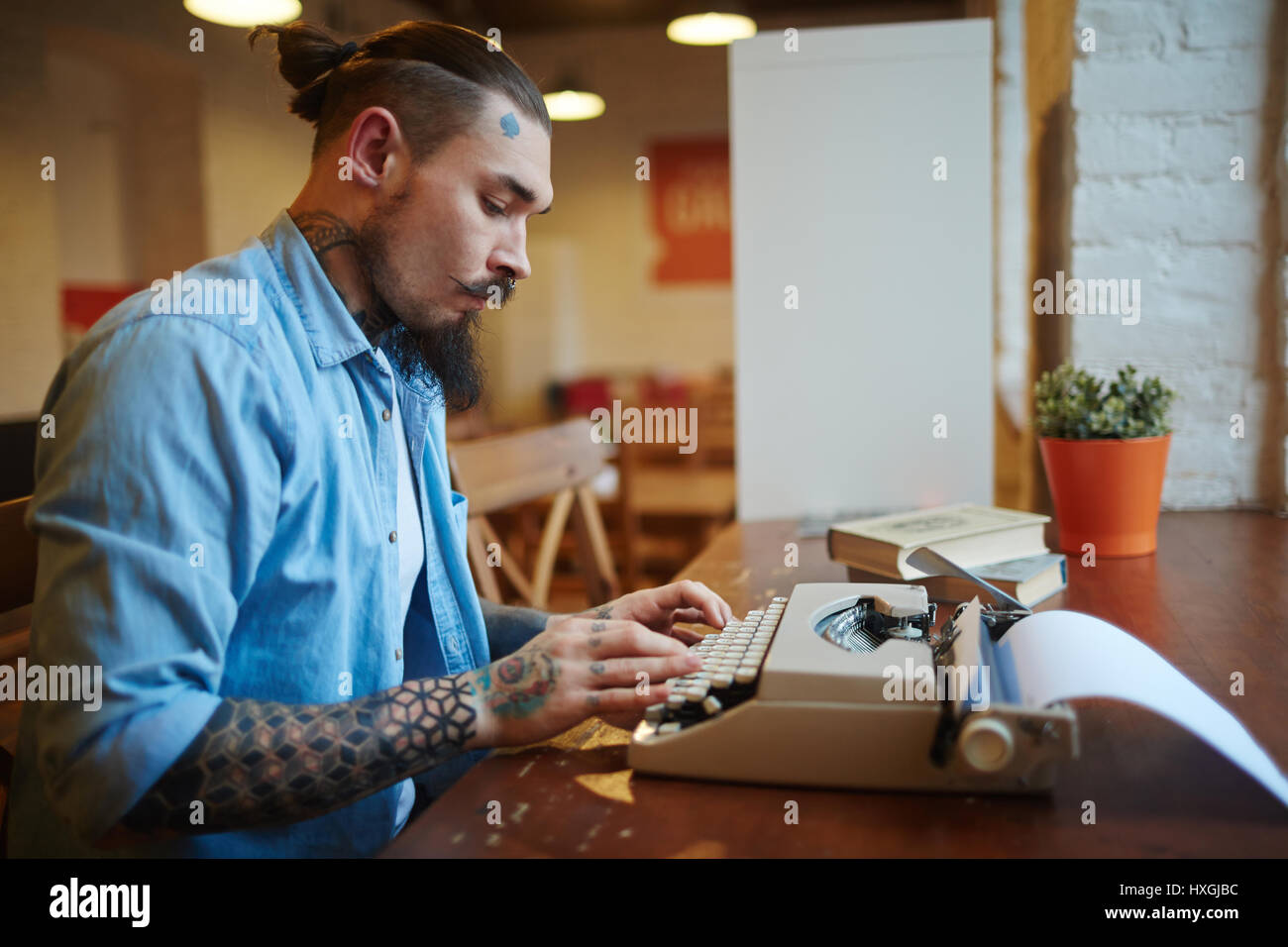 Side view portrait of stylish tattooed man using old-school vintage ...