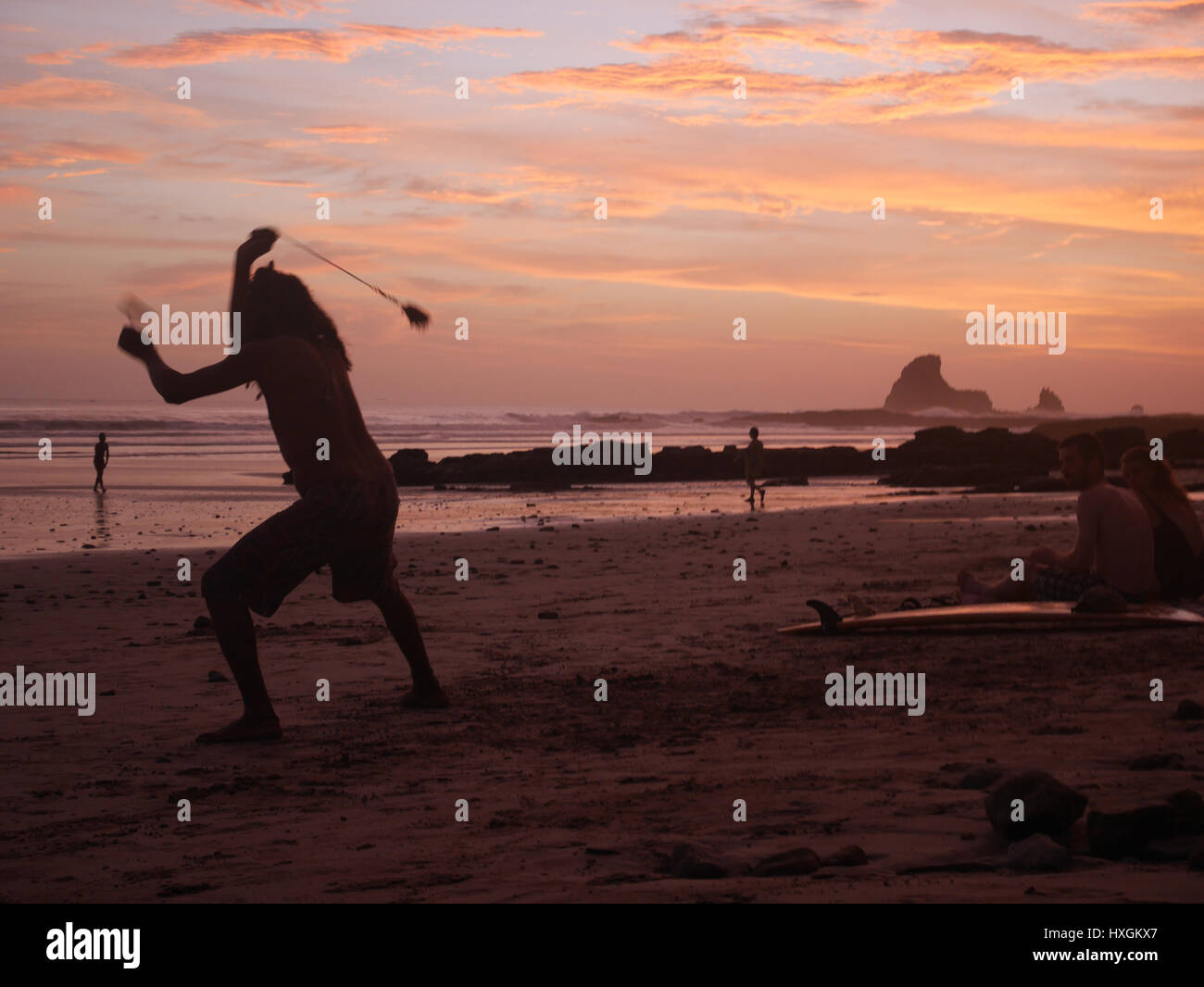 Indian men is dancing on a beach during sun his traditional dance with ...