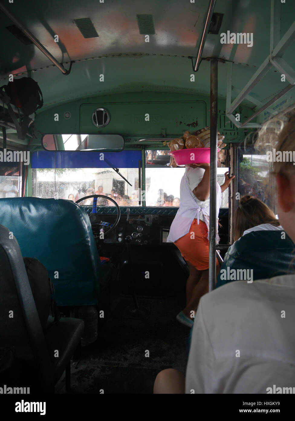 People sitting inside the chicken bus waiting for their cheap and ...