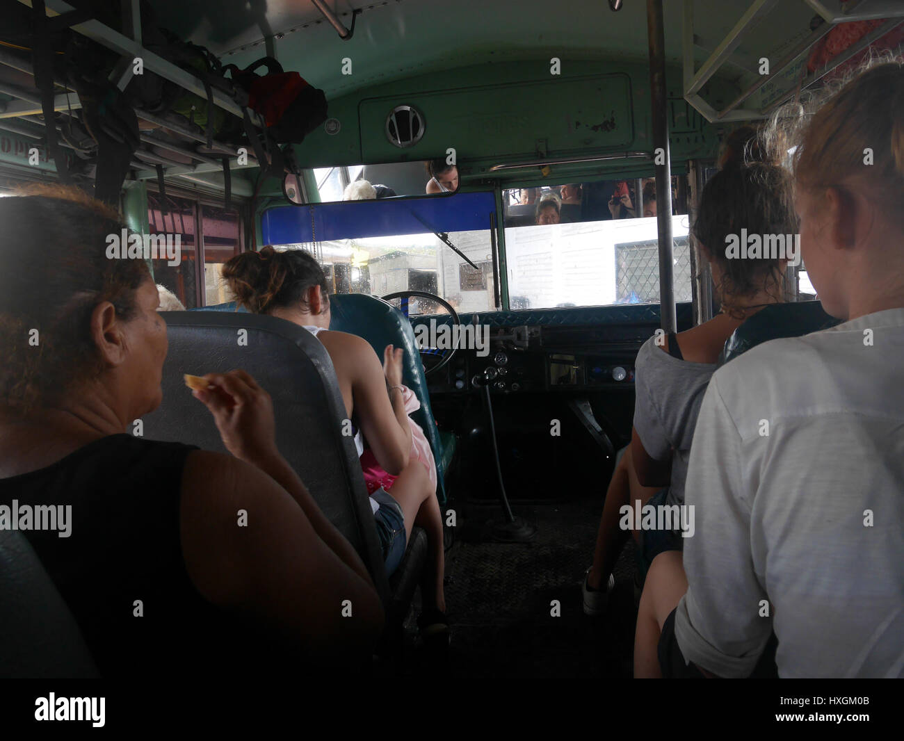 People sitting inside the chicken bus waiting for their cheap and ...