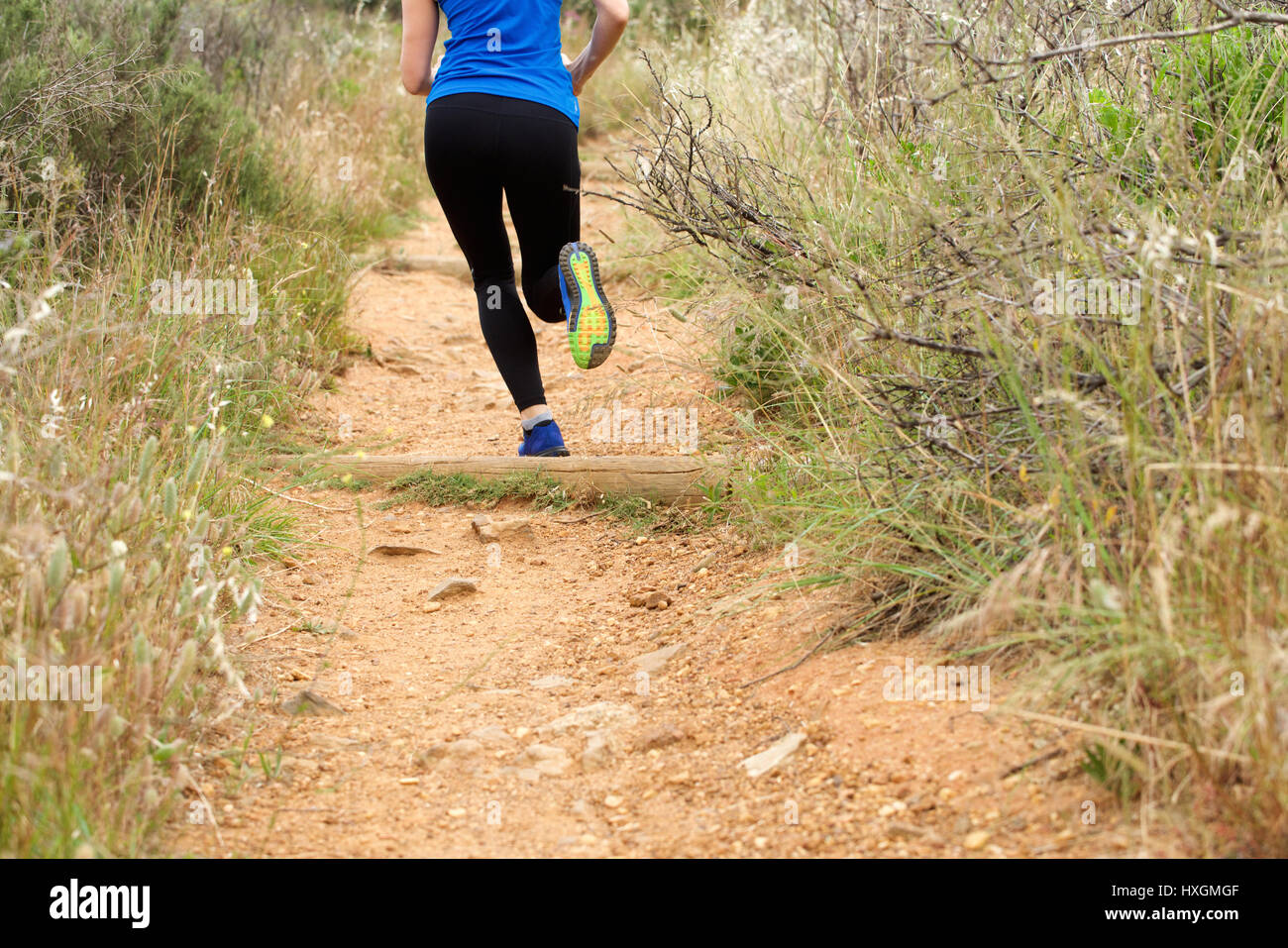 Portrait of the back of woman running on dirt path Stock Photo - Alamy
