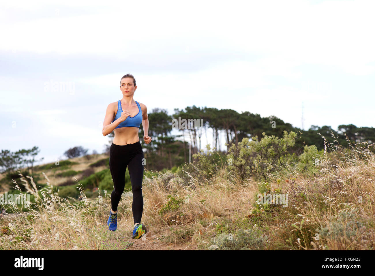 Full length portrait woman running outside in field Stock Photo - Alamy