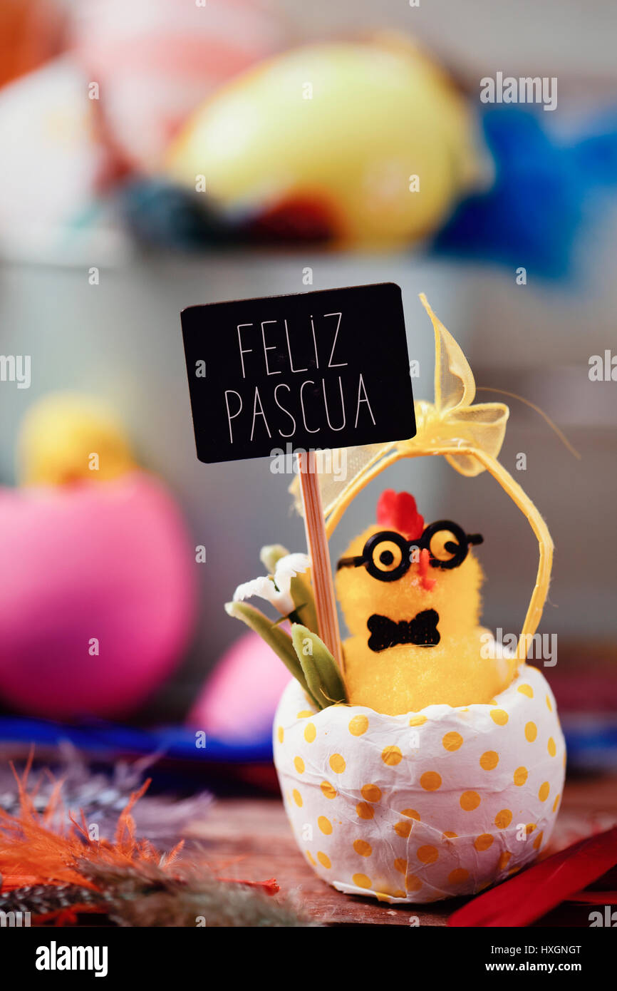 chick emerging from a cracked egg patterned with yellow dots holds a ...