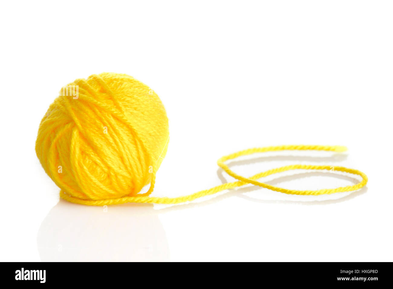 Yellow wool yarn ball isolated on white background Stock Photo - Alamy
