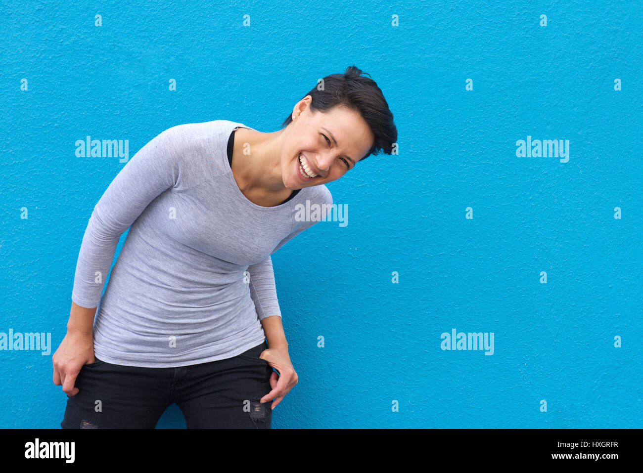 Portrait of a cheerful young woman with short hair laughing Stock Photo ...