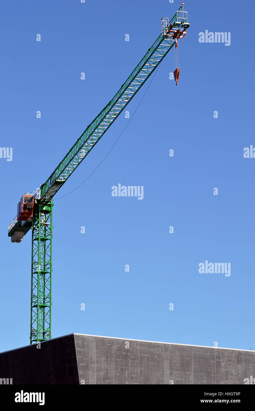 A crane prepares to lift from a building under construction Stock Photo ...