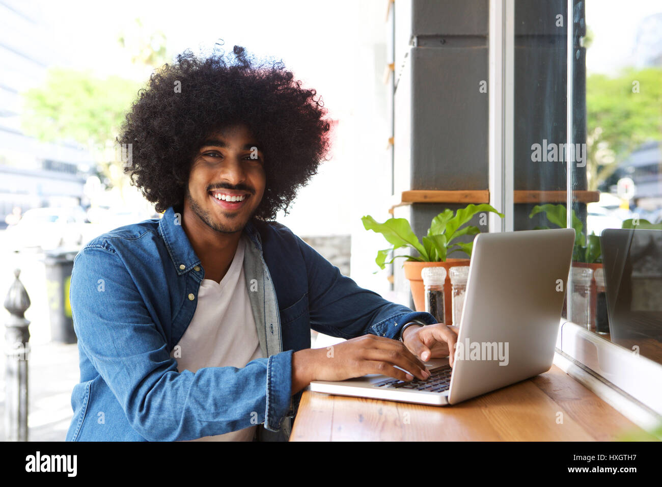 Portrait of a cool guy working with laptop Stock Photo - Alamy