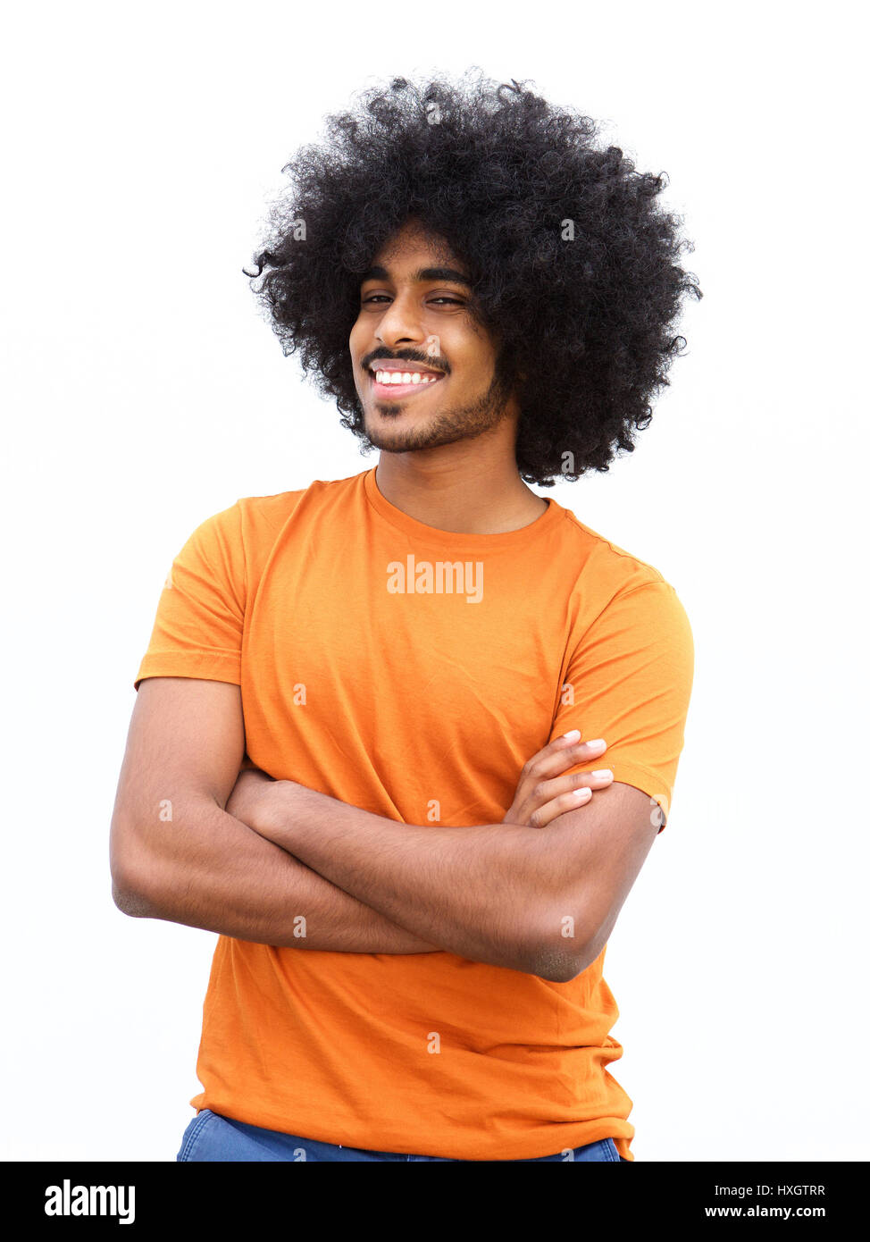 Portrait of a young man with afro smiling against white background ...
