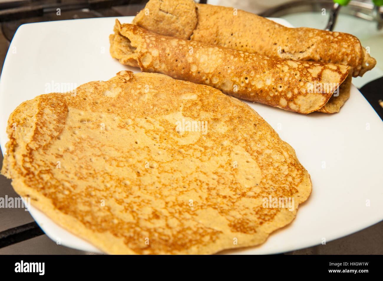 Quinoa crepes preparation : Rolling up quinoa crepes Stock Photo - Alamy