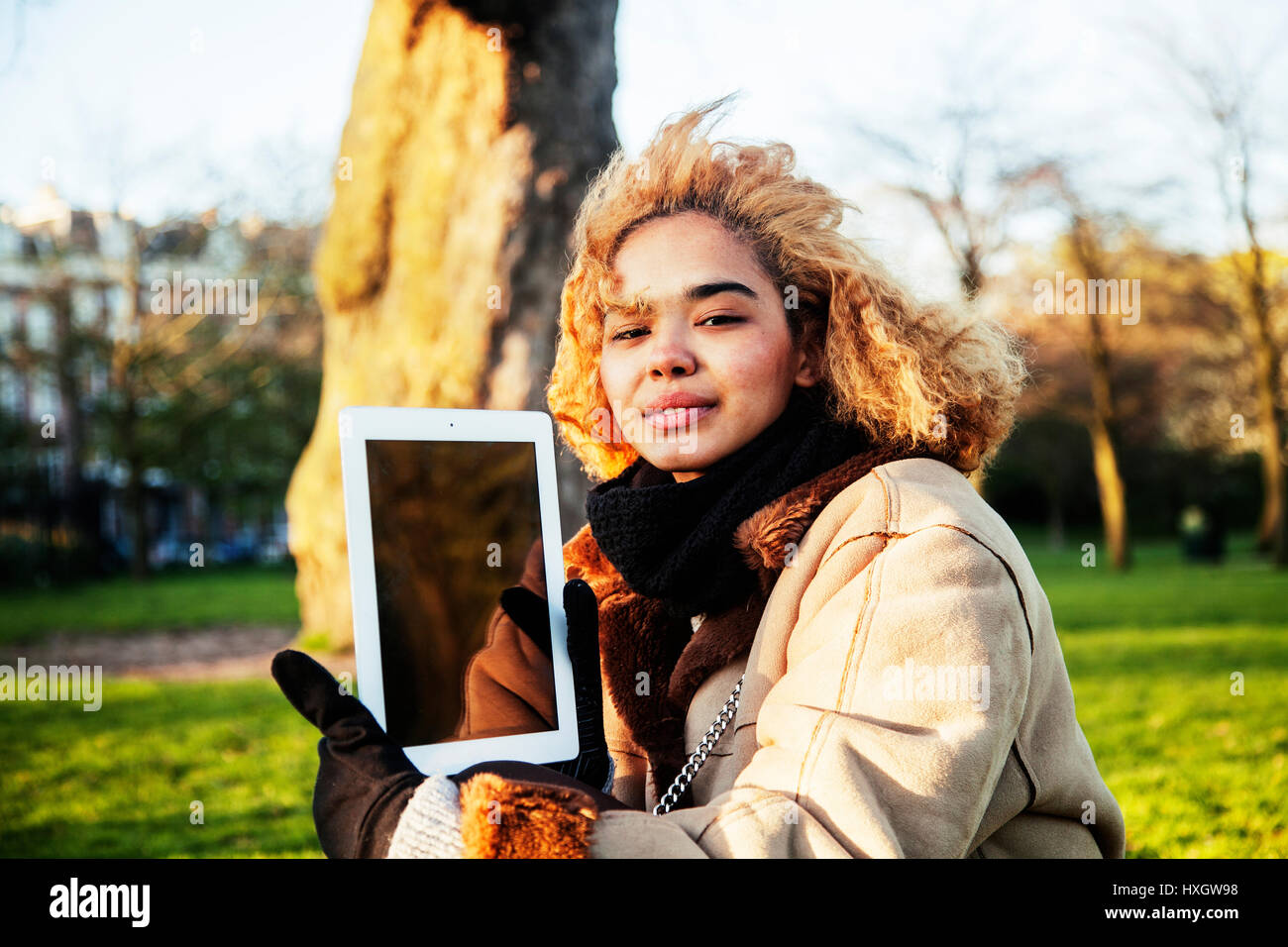 young cute blond african american girl student holding tablet an Stock ...