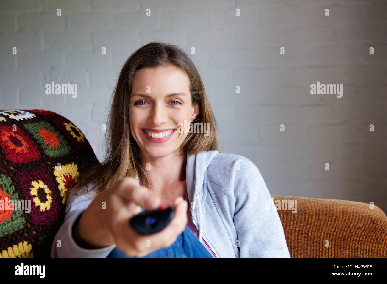 Woman with television remote hi-res stock photography and images - Alamy
