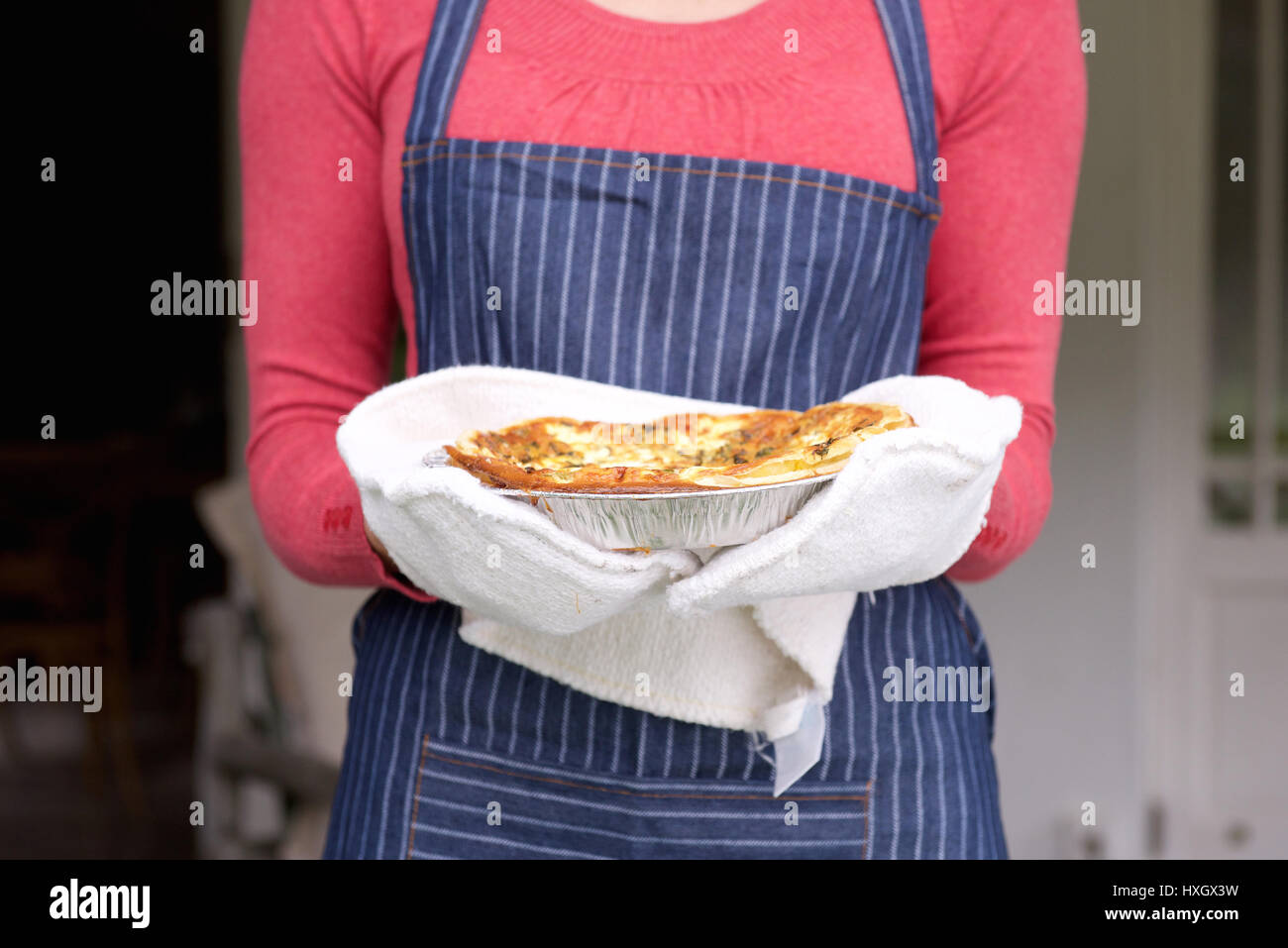 Part of woman holding fresh cooked pie Stock Photo - Alamy