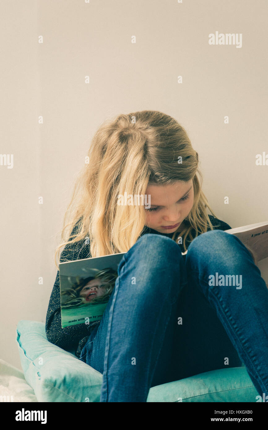 Girl sitting curled up hi-res stock photography and images - Alamy