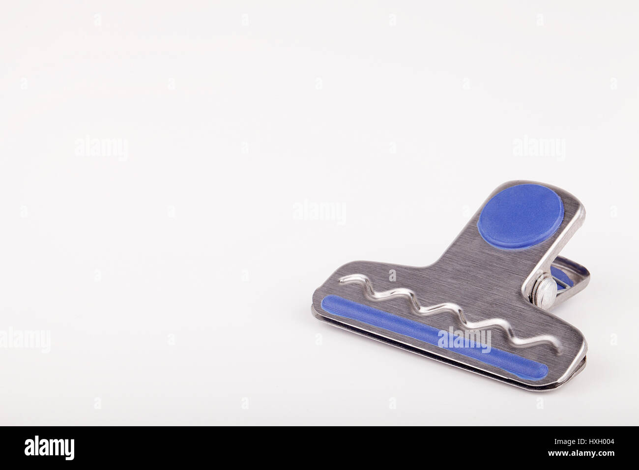 Magnetic paper clip on a white surface. Paperclip isolated on white ...