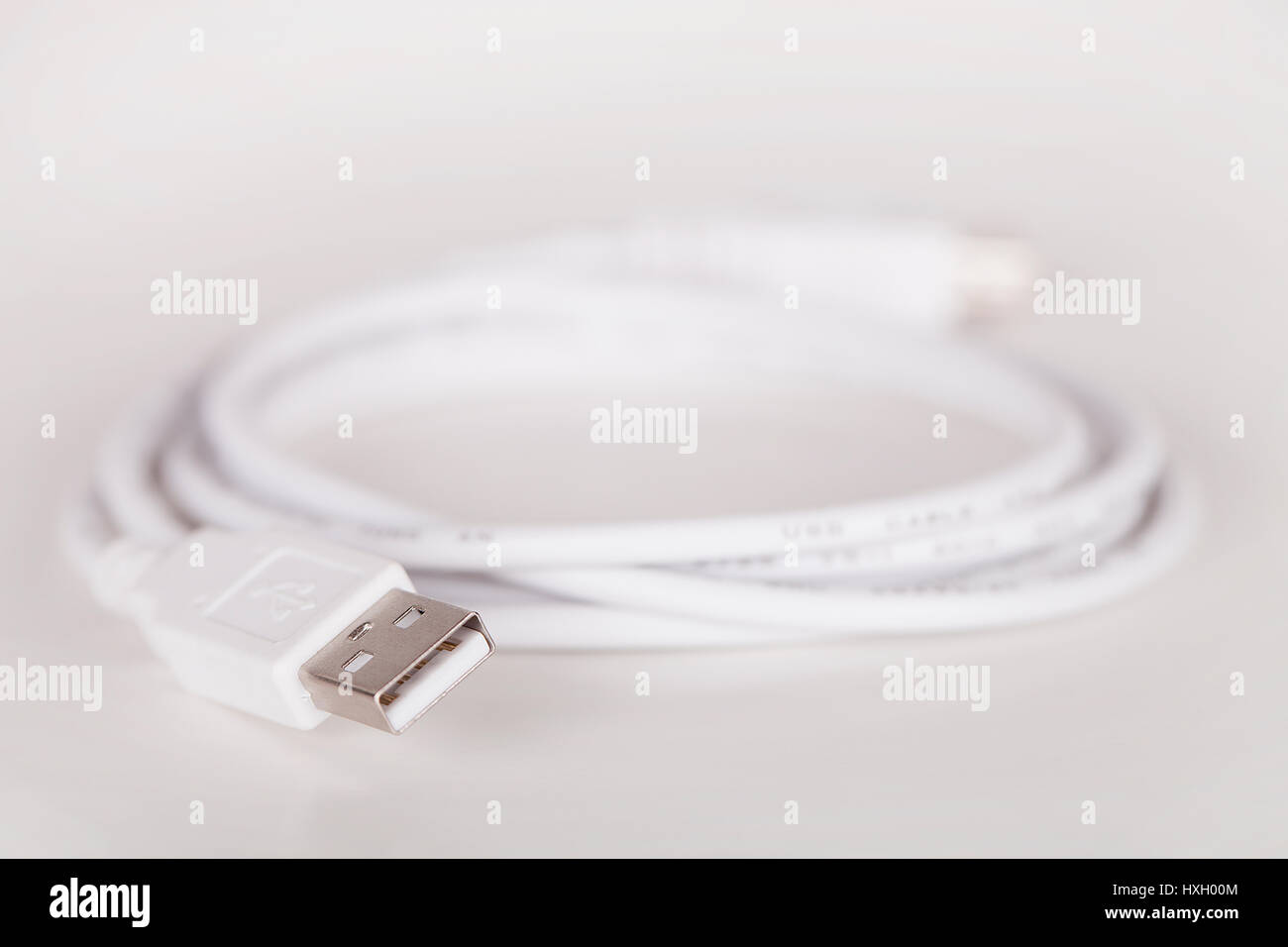 White USB cord isolated on white background Stock Photo - Alamy