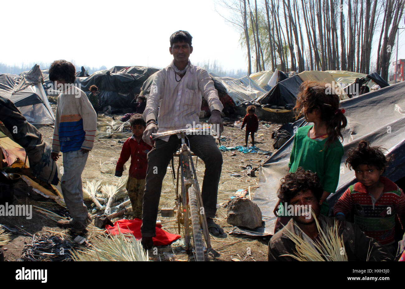 A group of non-local workers from Rajasthan busy in making brooms to ...