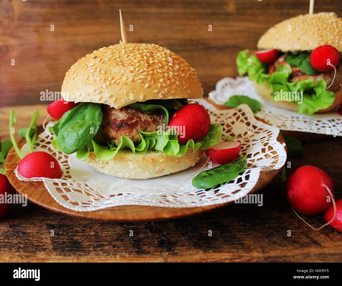 Homemade traditional burgers with beef,radish,lettuce, spinach , served ...