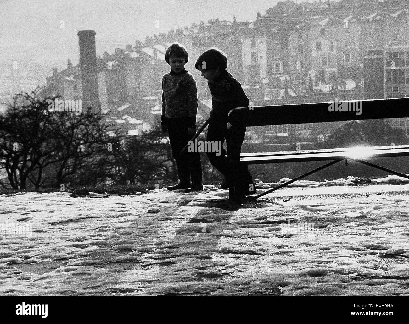 YOUNG BOYS PLAYING IN SNOW ENGLAND 01 January 1970 Stock Photo - Alamy