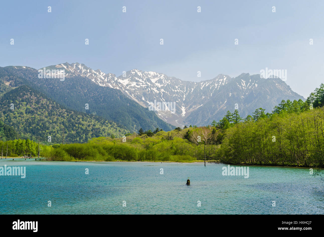 Hotaka mountain range and taisho ike pond in spring at kamikochi ...