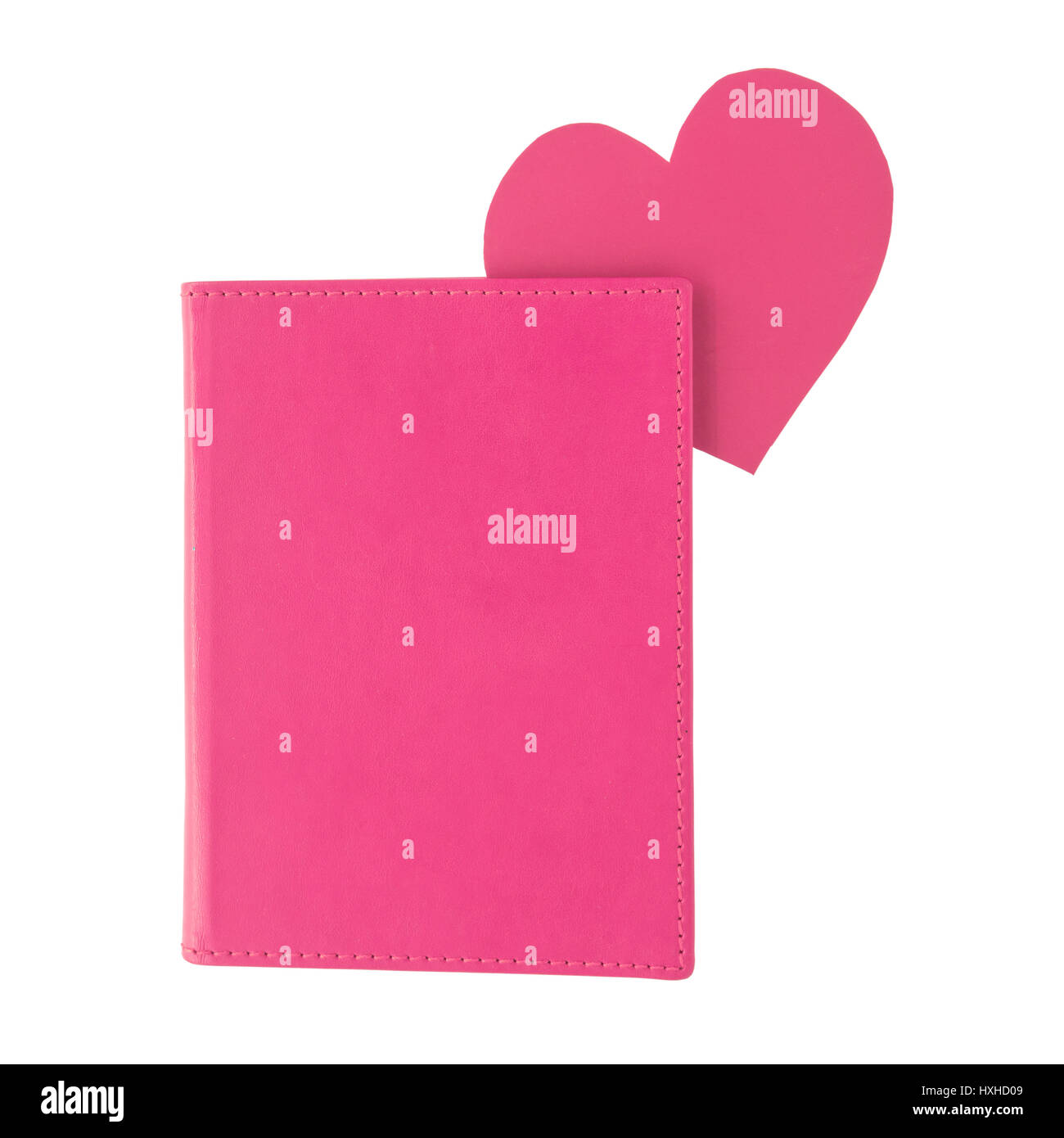 Pink paper heart bookmark inside a pink book isolated on white ...