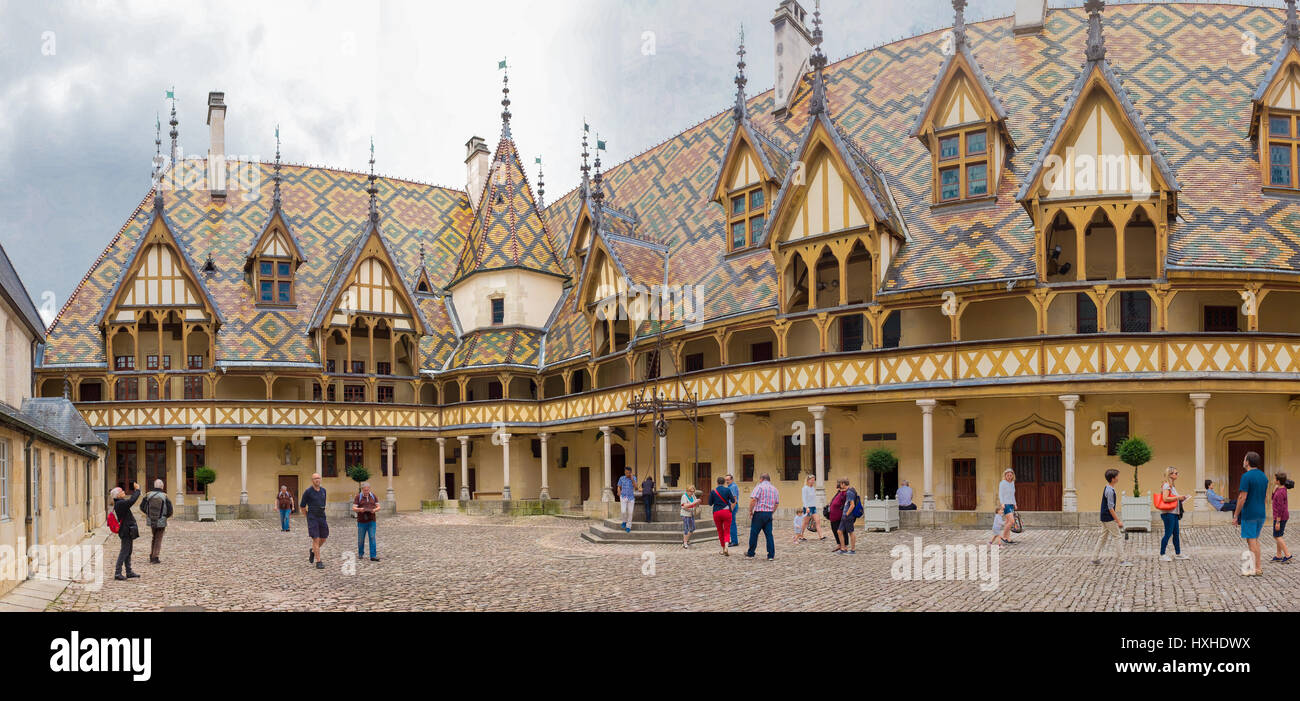 Panorama of European square at Beaune's hospital with people strolling ...