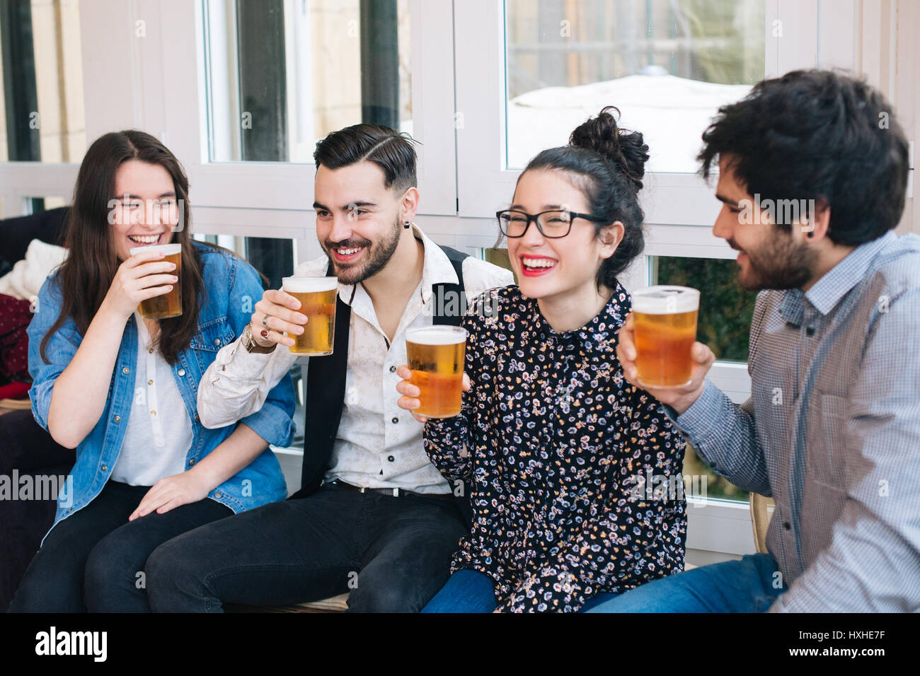 Young group of friends having fun in a bar drinking beer Stock Photo ...