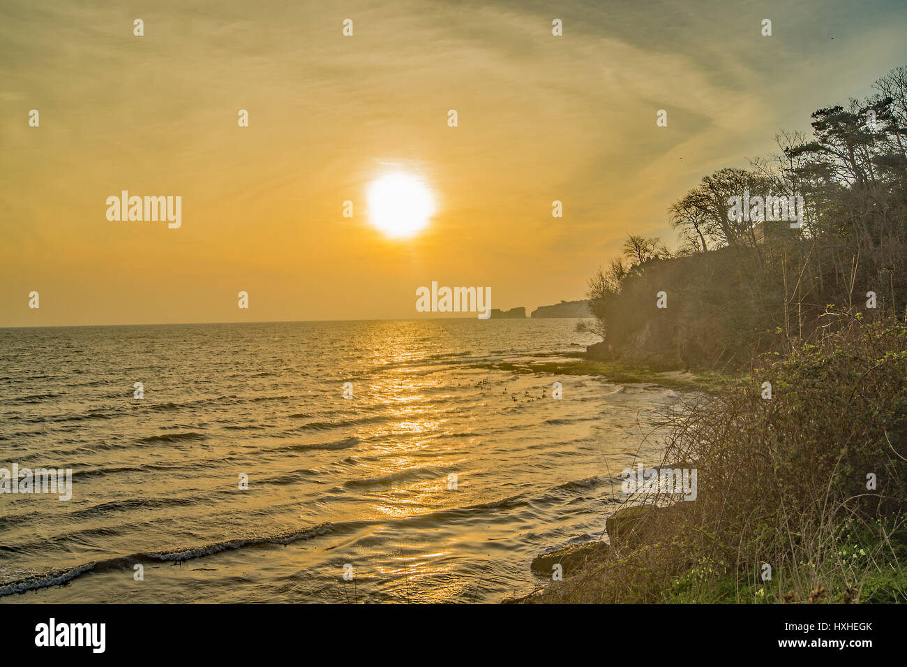 Sunrise at the Dorset beach Stock Photo - Alamy