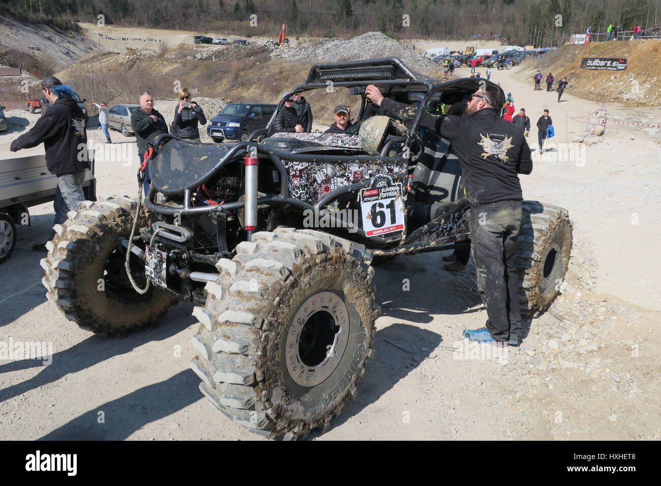 The driver of off-road car is checking his all-terrain vehicle before ...