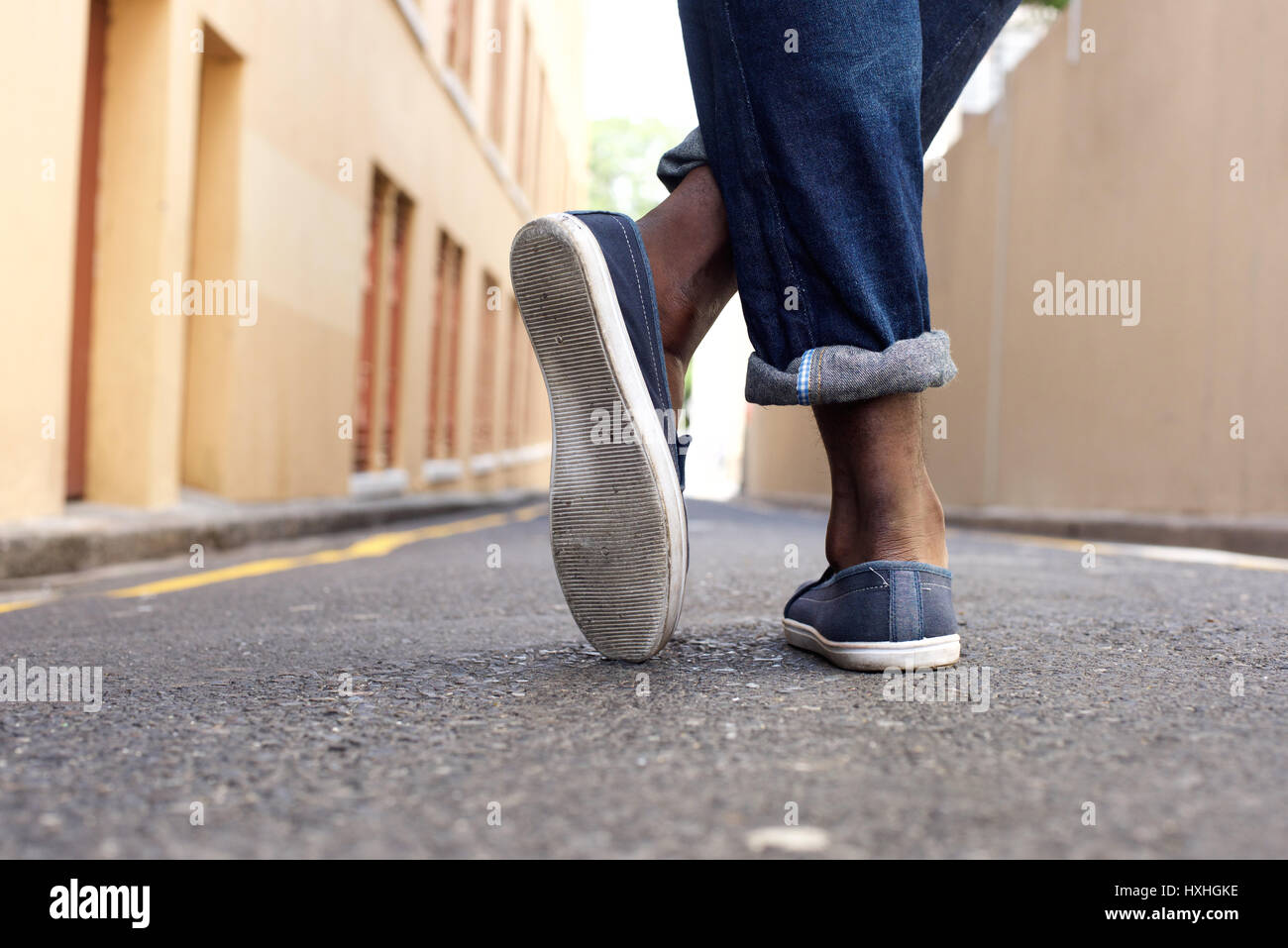 Close up of ground level man standing on street Stock Photo - Alamy
