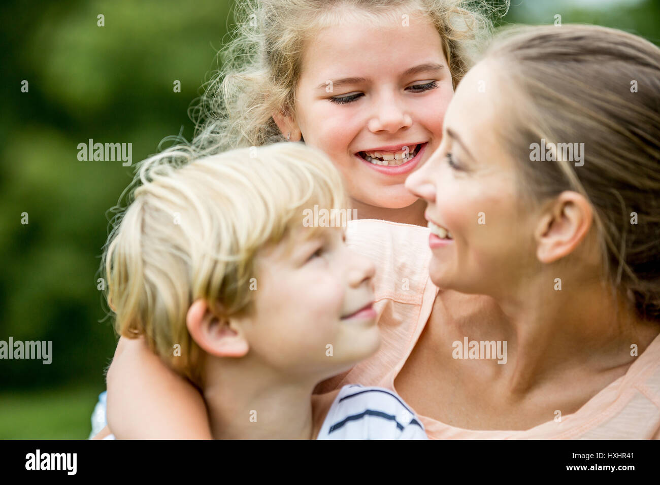 Happy mother with her family together in the park Stock Photo - Alamy